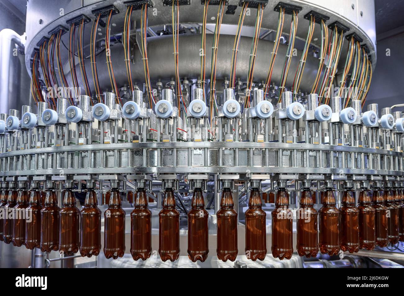Filling plastic bottles with various drinks on an automatic filling ...