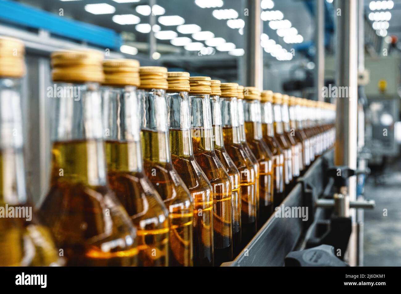 Alcohol liquor closed bottles with caps at production line Stock Photo ...