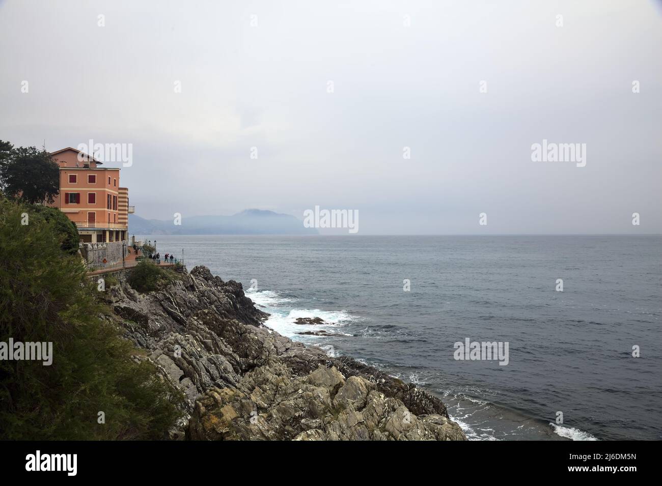 Houses on a cliff by the sea on a cloudy and rainy day Stock Photo - Alamy