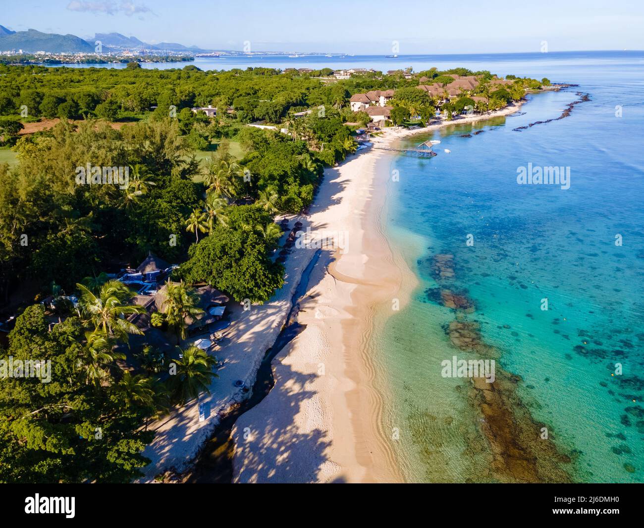 drone aerial view of a tropical beach, men and woman walking a tropical ...