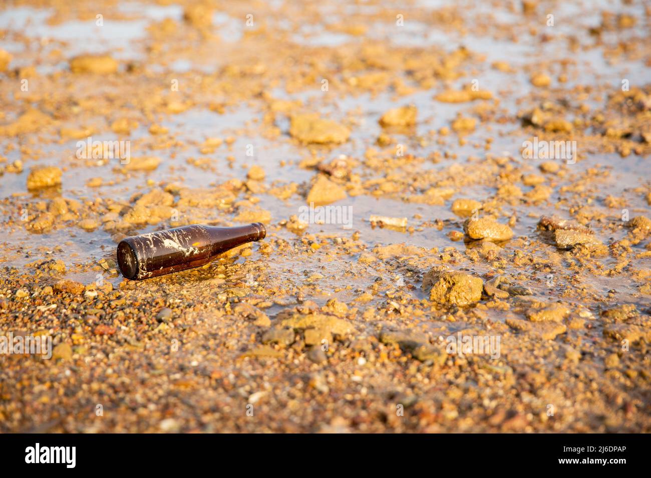 Bottled water washed away by seawater, marine debris Stock Photo - Alamy