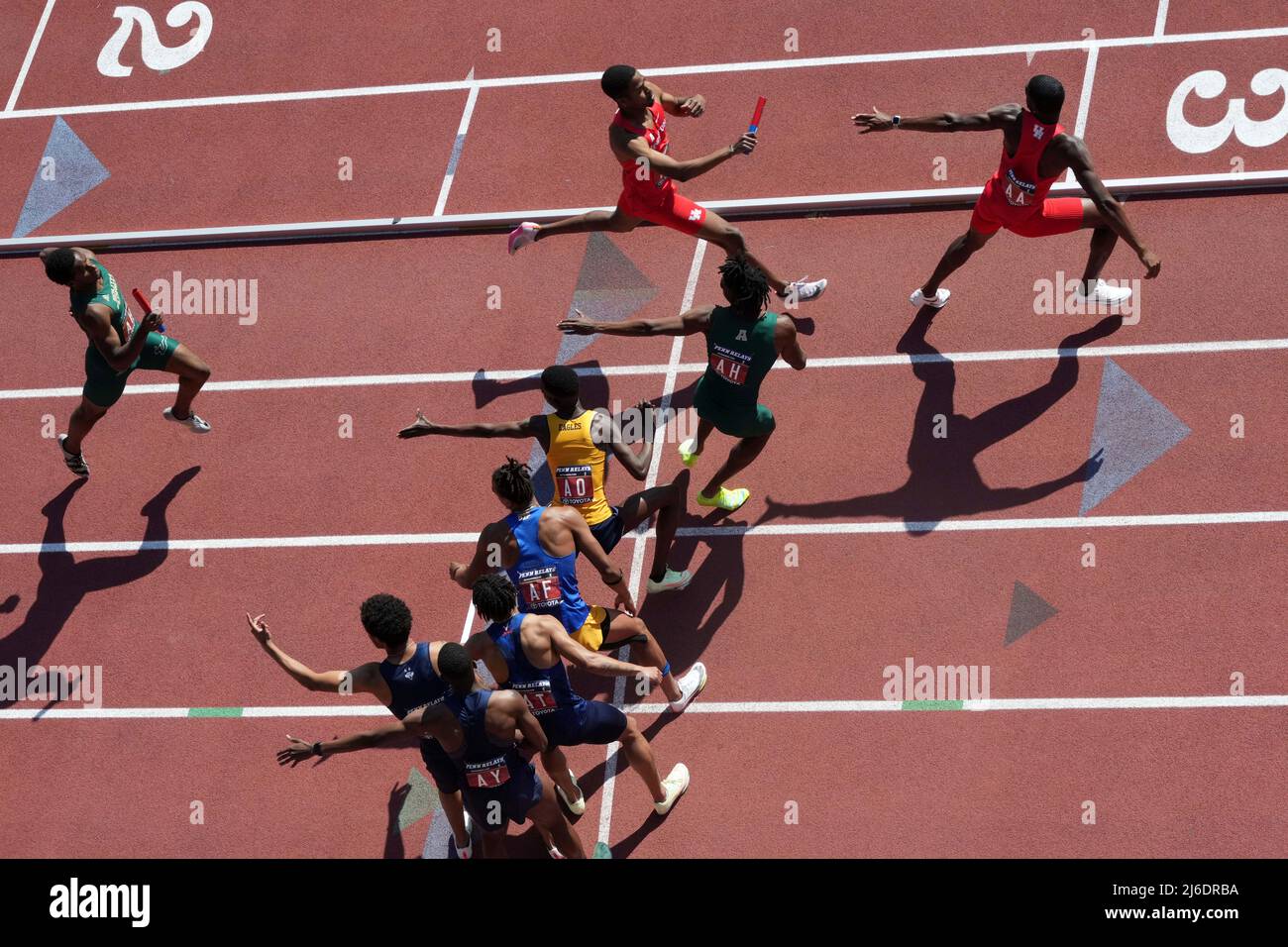 Runenrs handoff the baton in a Championship of America 4 x 400m relay ...