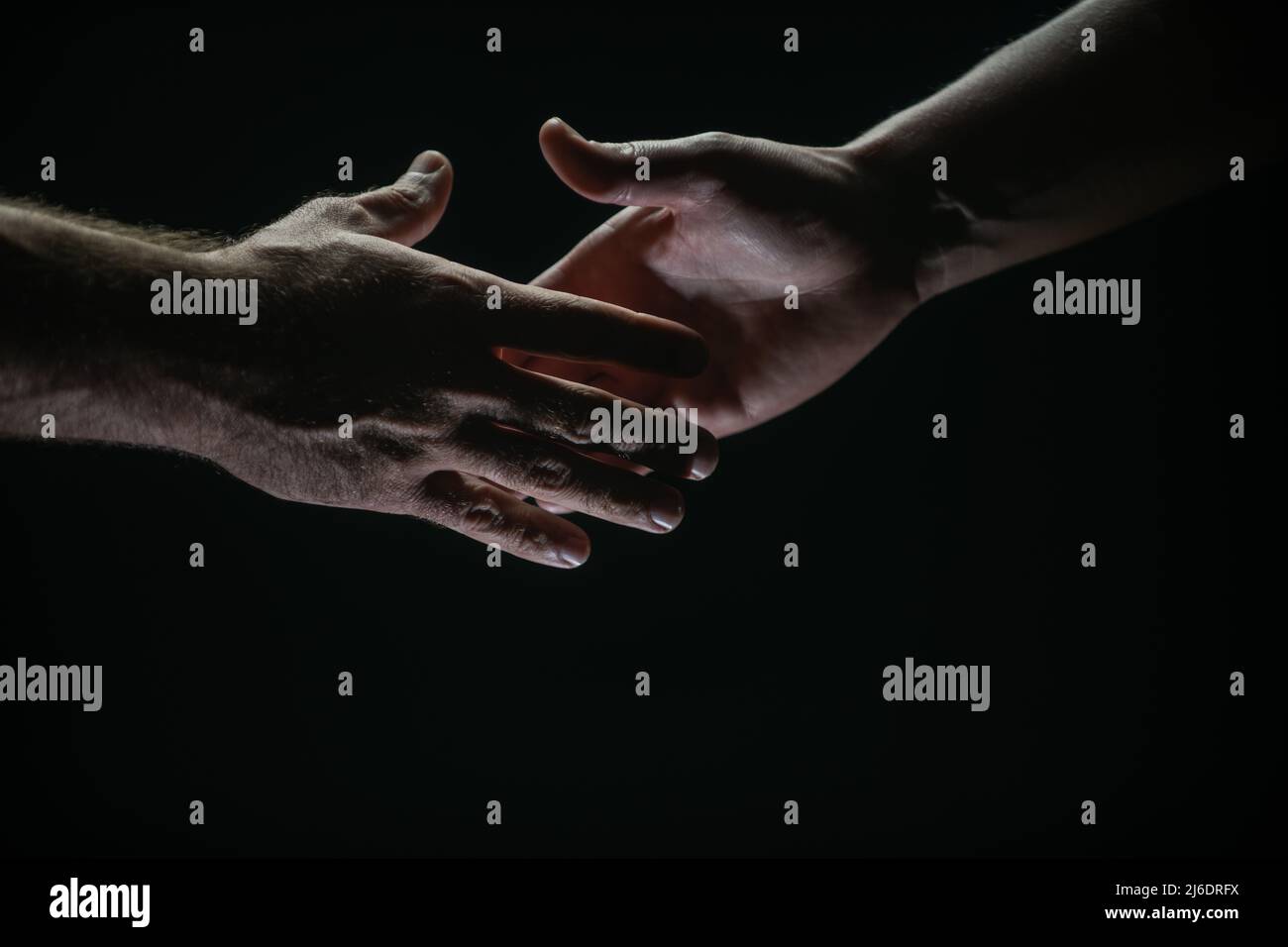 Handshake. Men holding hands isolated on black. Connection and human ...