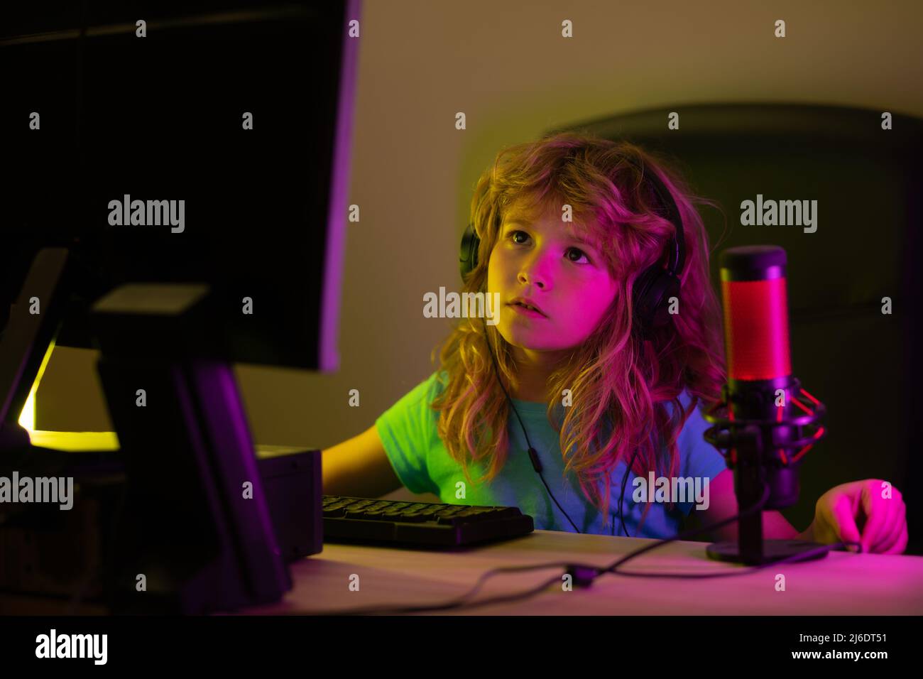 Cute preschool child watching video lesson by laptop. Child using ...