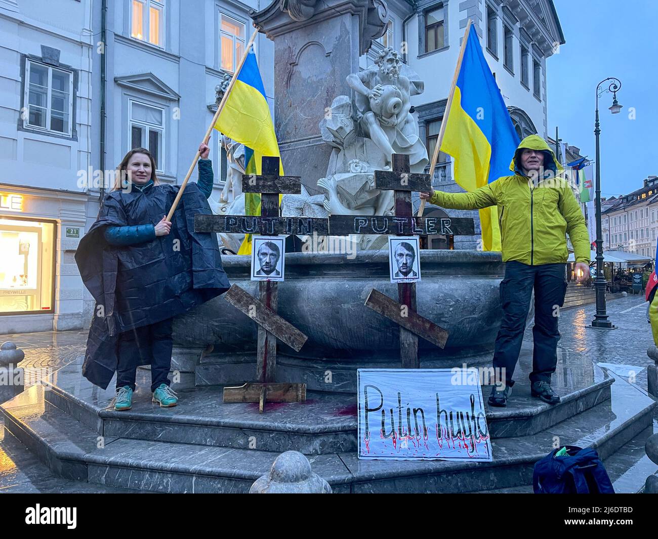 People with Putin's posters on cross of crucifixion and inscription ...