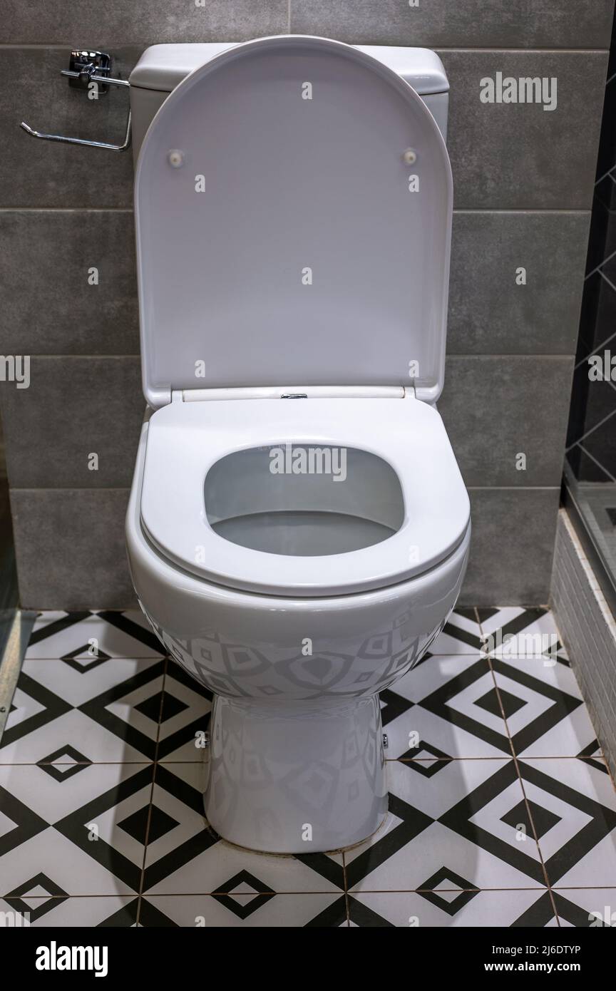 Toilet bowl in modern bathroom interior. Close up view of white ceramic ...