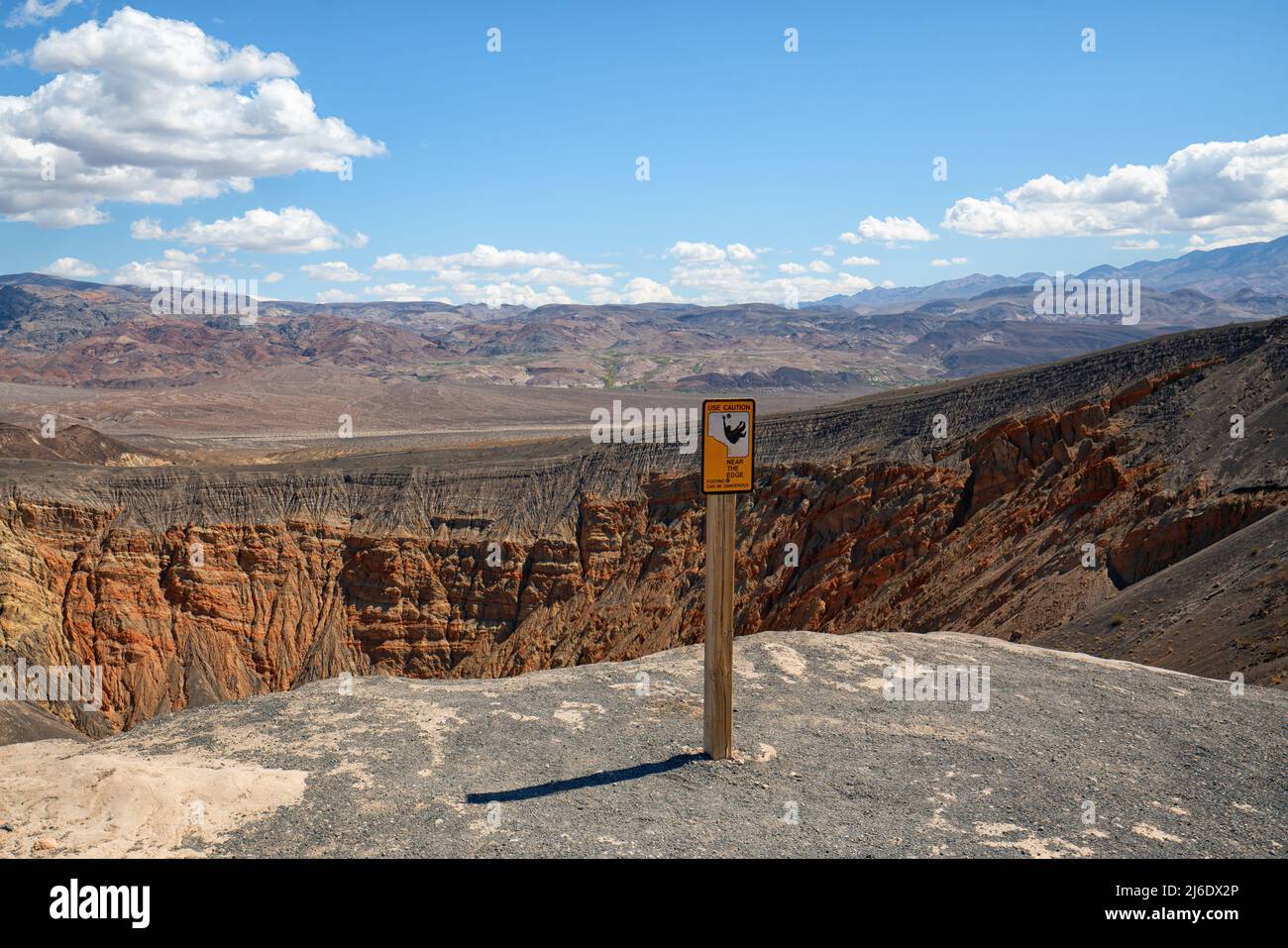 Desert hiking, Ubehebe Crater view point and warning sign "Use caution ...