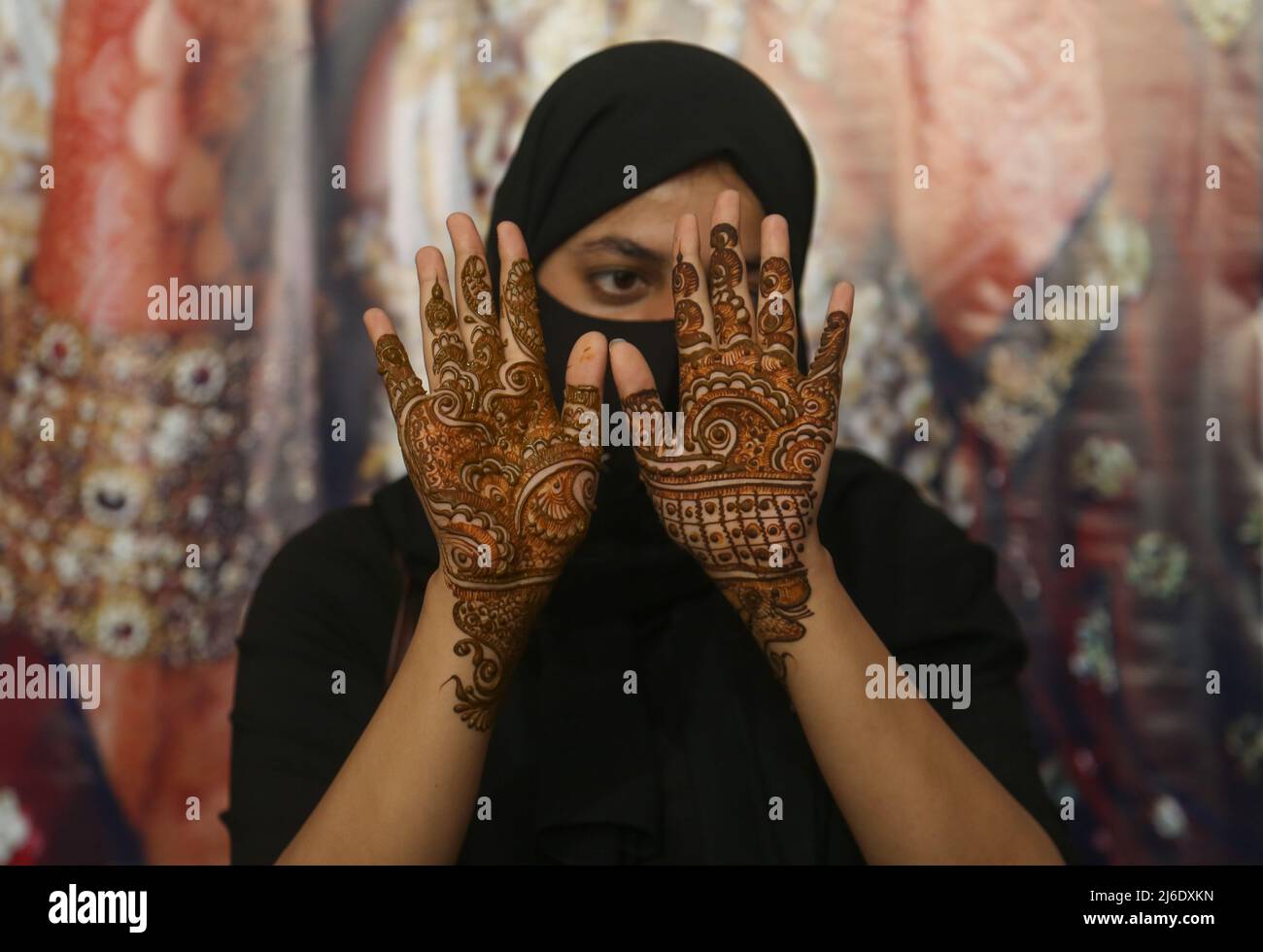 Kashmiri Muslim girl displays her henna decorated hands at a roadside ...