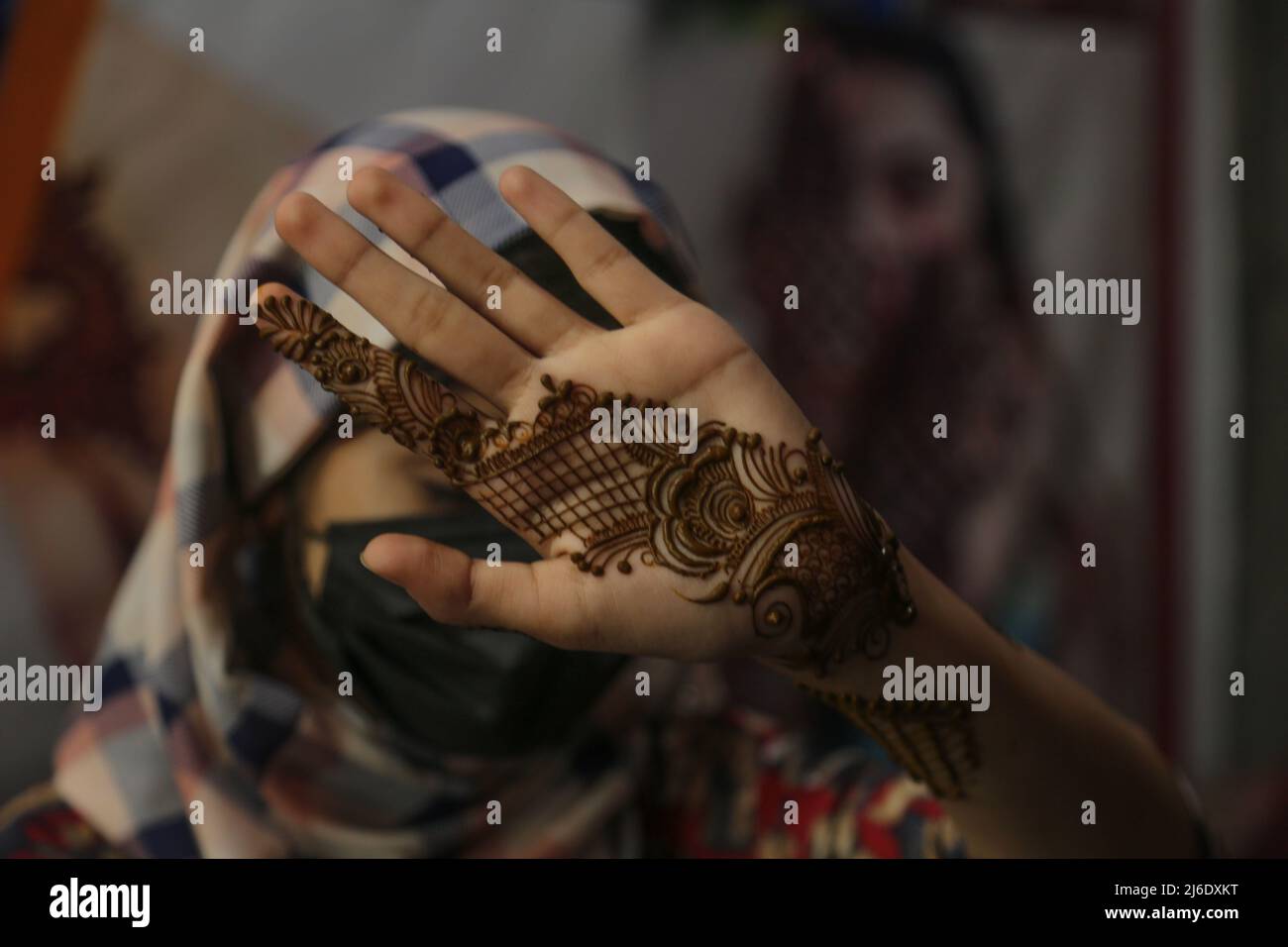 Kashmiri Muslim girl displays her henna decorated hands at a roadside ...