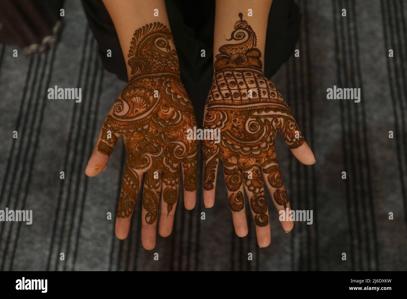 Kashmiri Muslim girl displays her henna decorated hands at a roadside ...