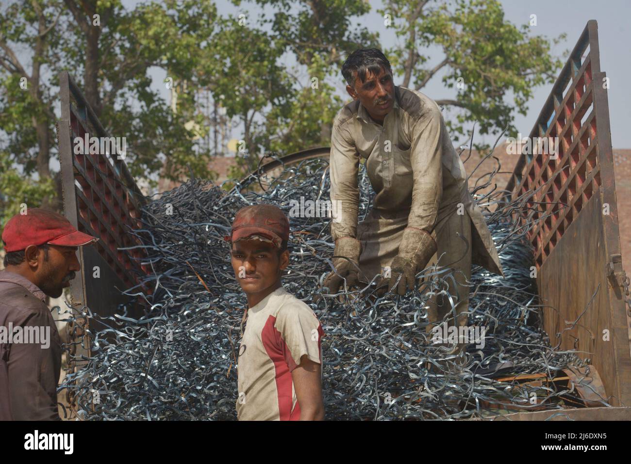 Pakistani laborers are busy in routine work at their workspace during ...
