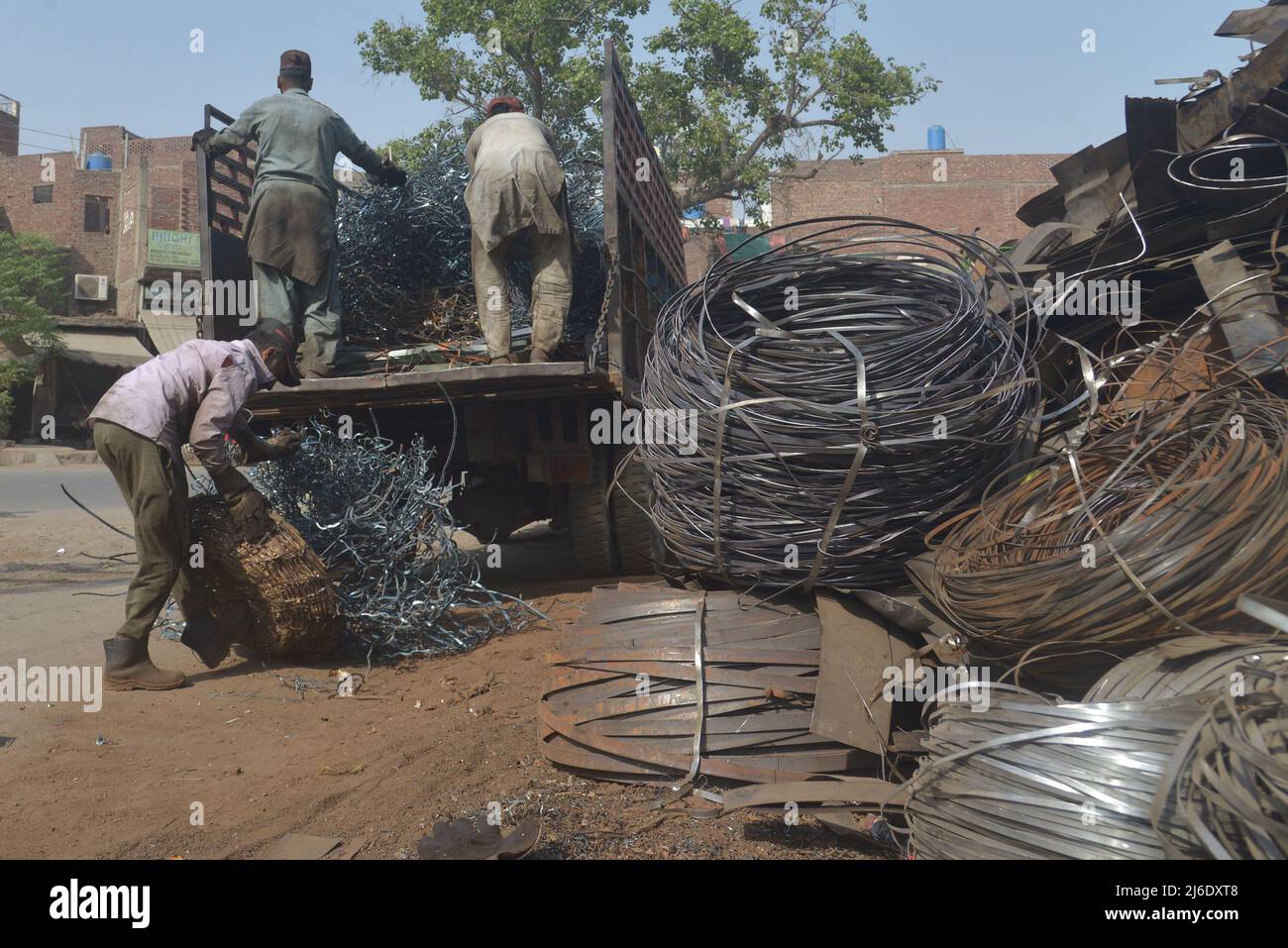 Pakistani laborers are busy in routine work at their workspace during ...