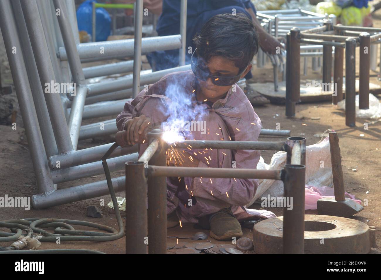 Pakistani laborers are busy in routine work at their workspace during ...
