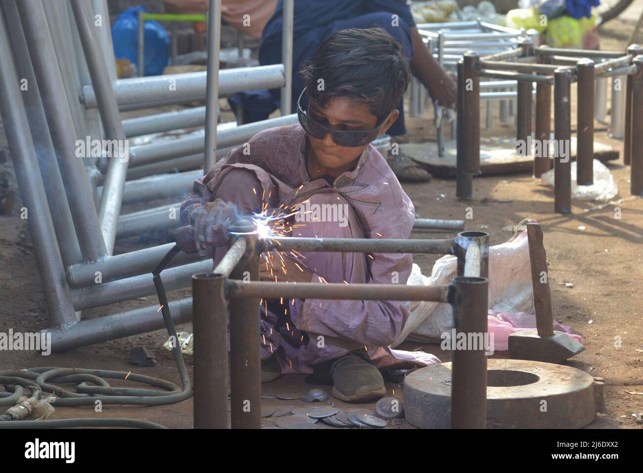 Pakistani laborers are busy in routine work at their workspace during ...