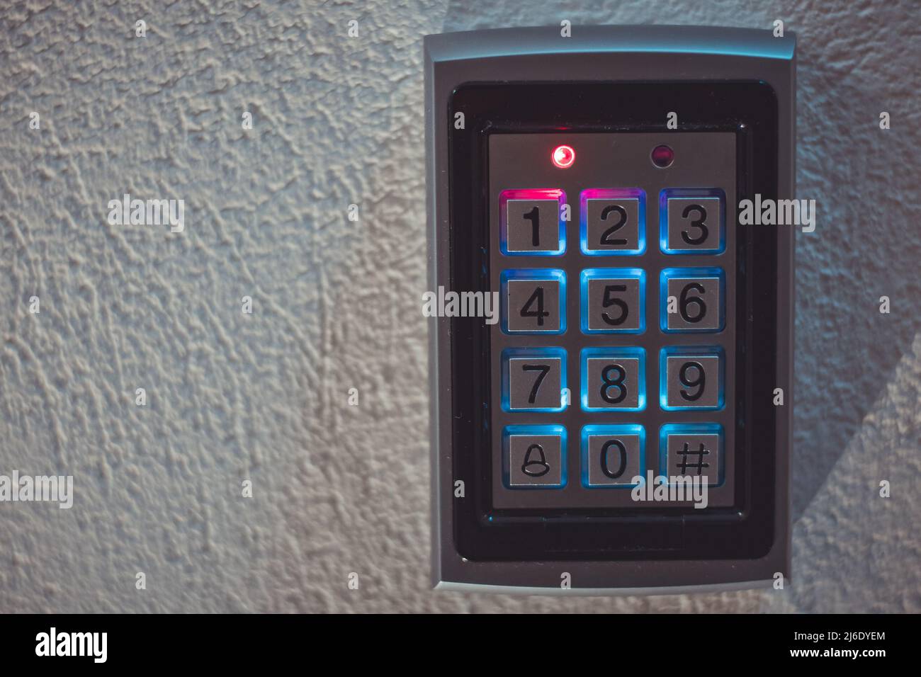 Frontal view of modern digital combination access lock, illuminated ...