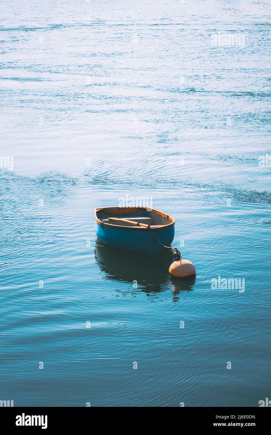 Empty rowing boat on the water Stock Photo - Alamy