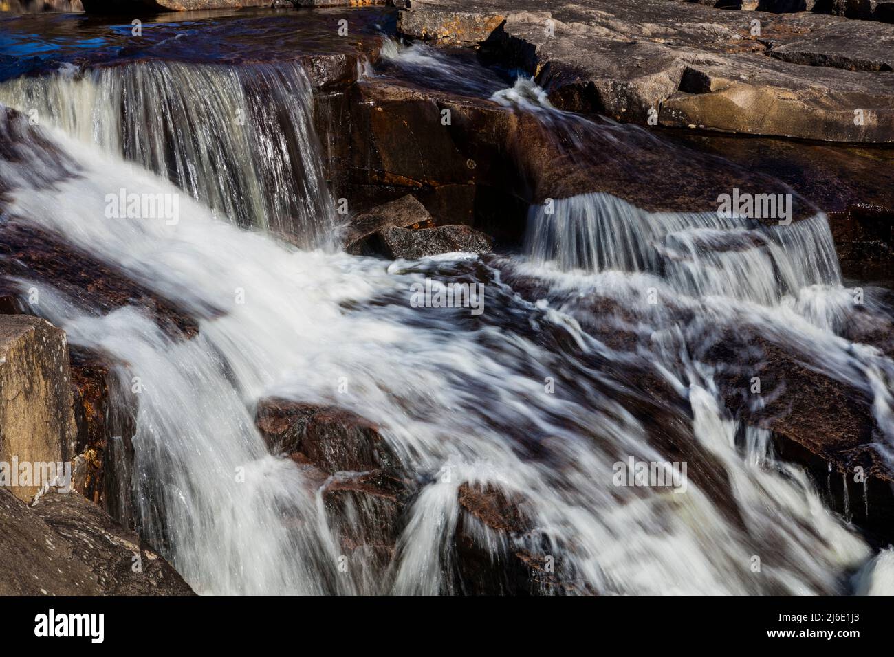 Beautiful waterfall surrounded by rocks and slabs at Reinsfoss in ...