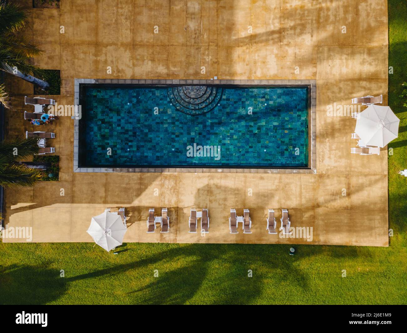 swimming pool with beach chairs and lunch table at a luxury resort ...