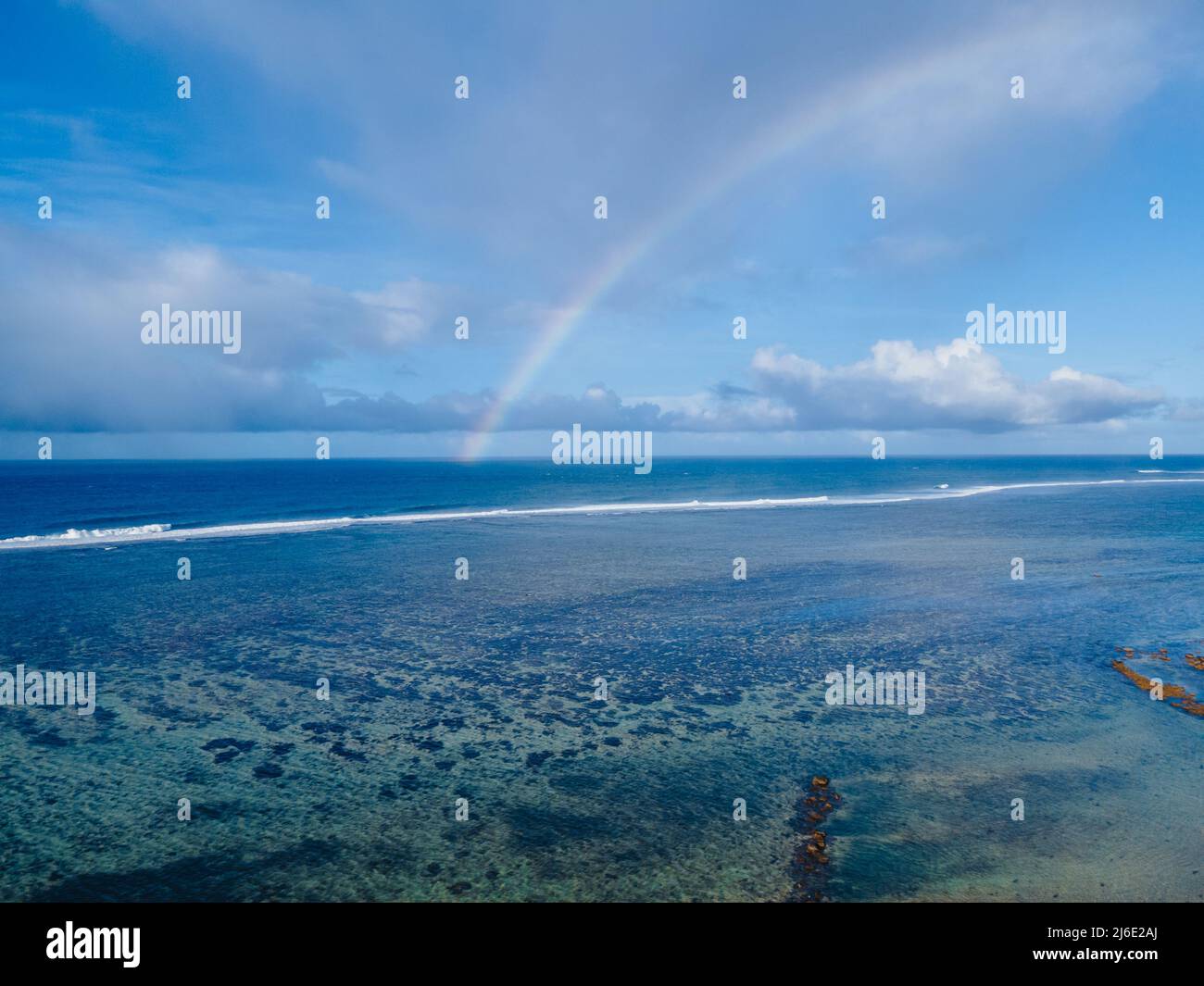 drone aerial view of the ocean with rainbow, rainbow in the ocean of ...