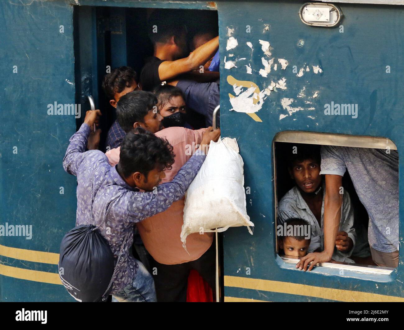 Bangladeshi people are seen inside a train as they travel returning ...