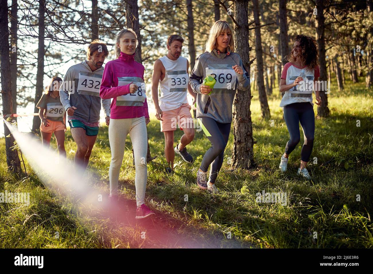 Adventure trail running on a mountain. Athletic people running enjoying ...