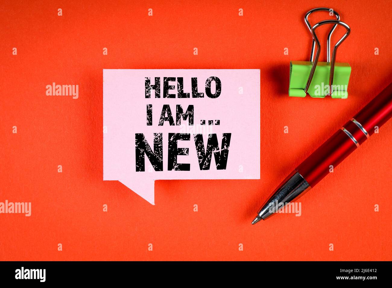 HELLO I AM NEW. Pink speech bubble on an orange background Stock Photo ...
