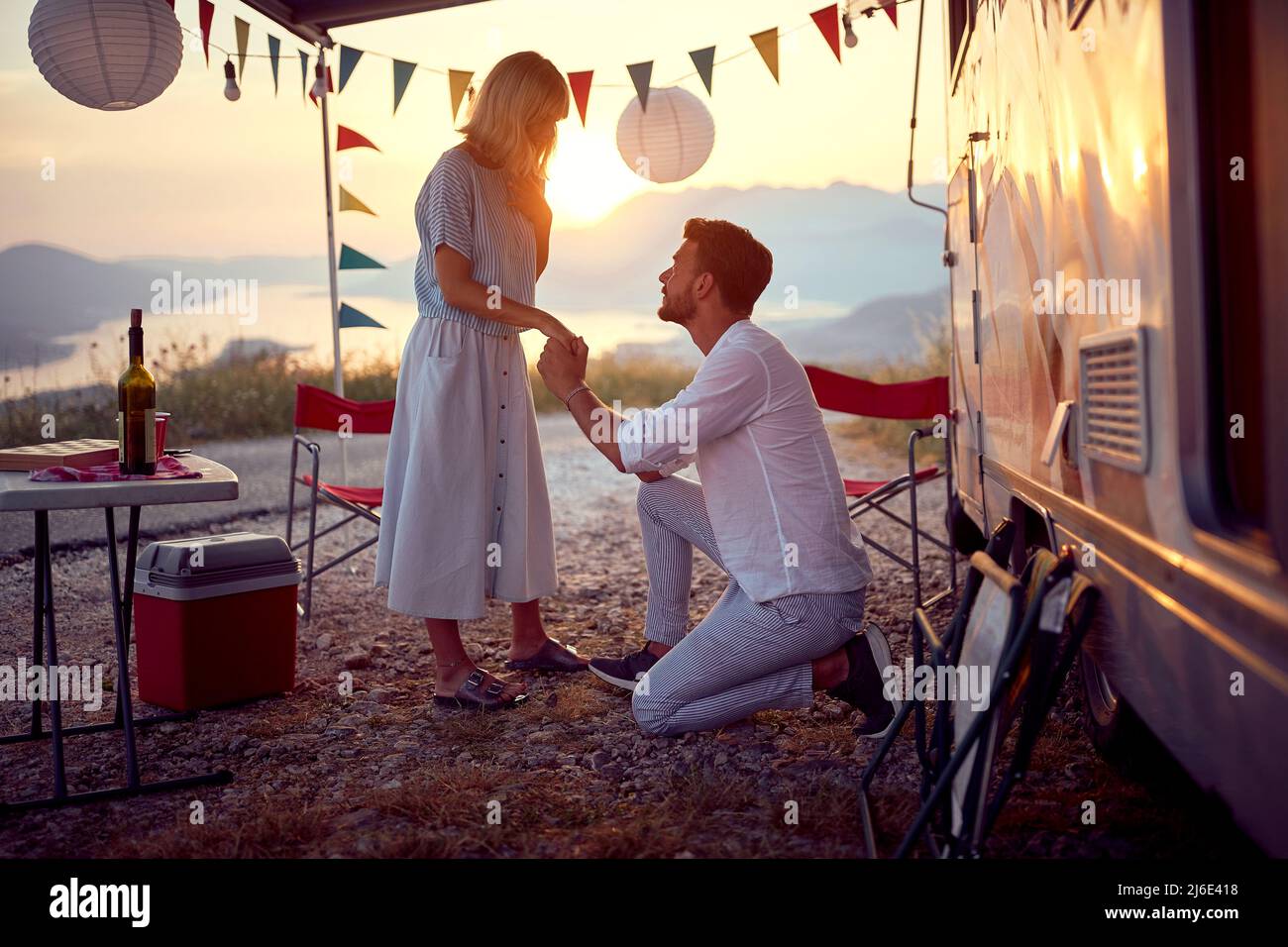 A young man is proposing his girlfriend during a vacation in the camp ...