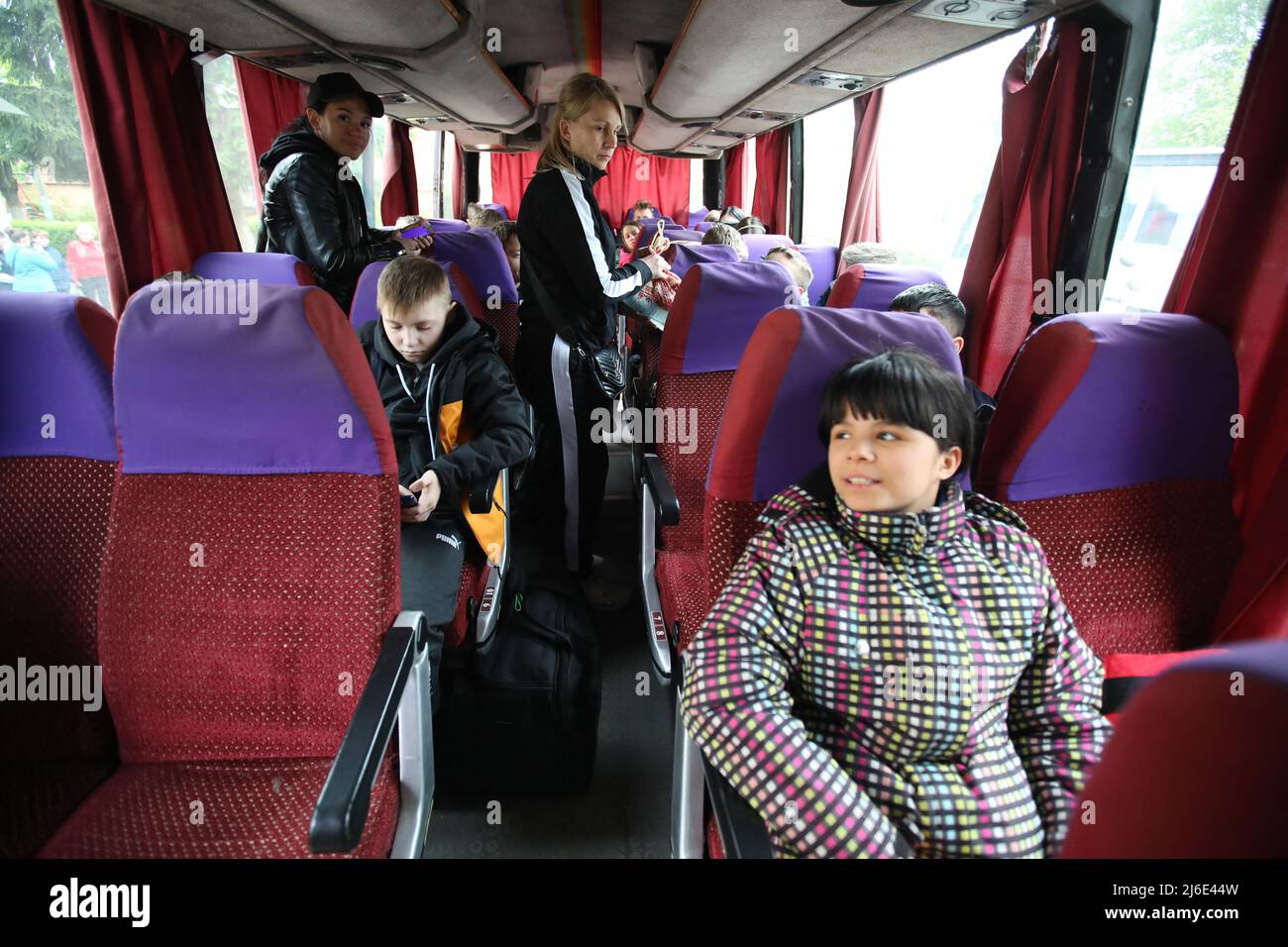 Children from an orphanage in Kryvyi Rih sit on a bus before starting ...