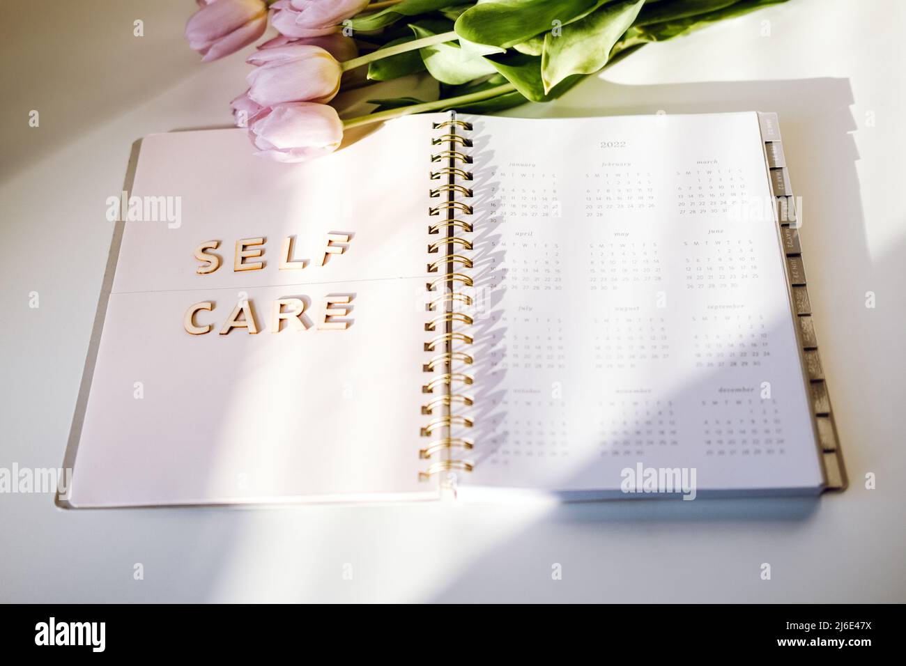 Self Care, wellbeing concept with open notebook, Self care word, tulip ...