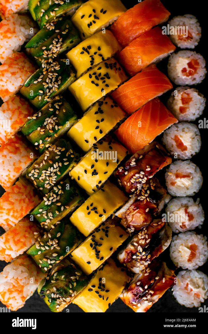Assorted japanese sushi rolls on black background. Asian or Japanese ...