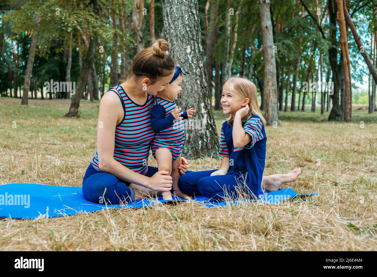 Happy family young mother embrace cute little baby children daughters ...