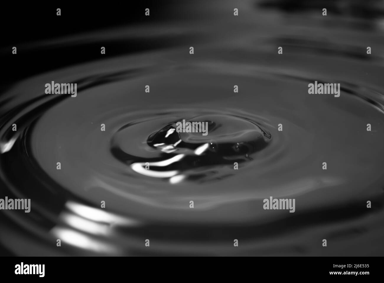 Oil stain. Wave circles from a drop on a greasy liquid surface. In the ...