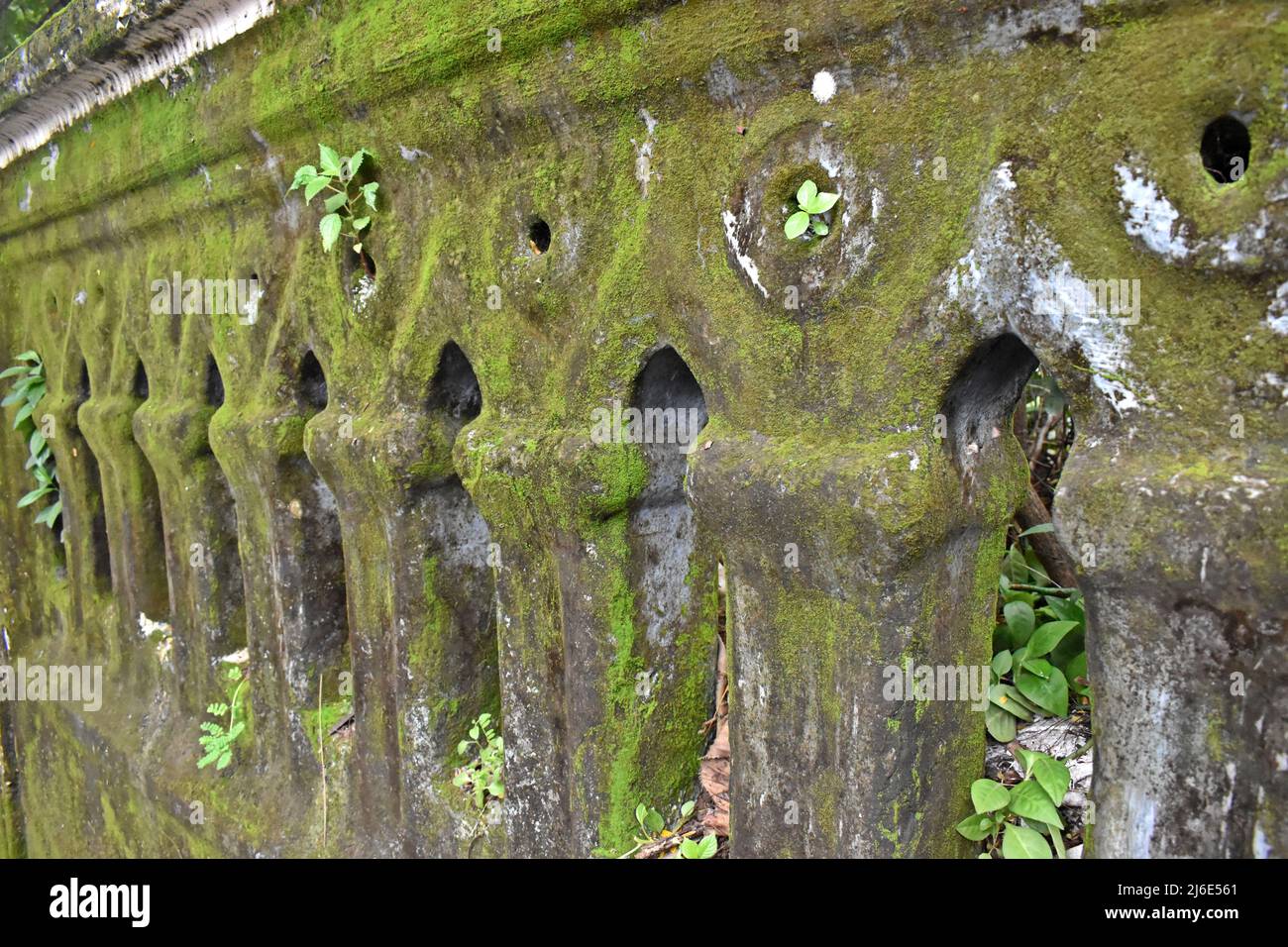 Moss-covered stone wall of an old church's architectural front Stock ...