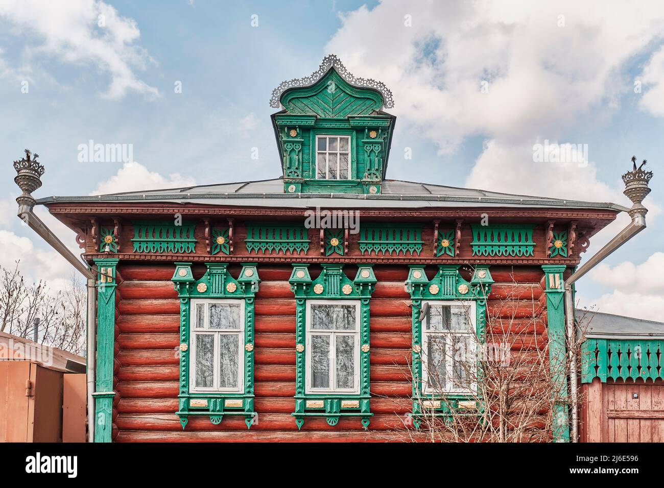 Facade of russian log house with dormer window on roof and carved ...