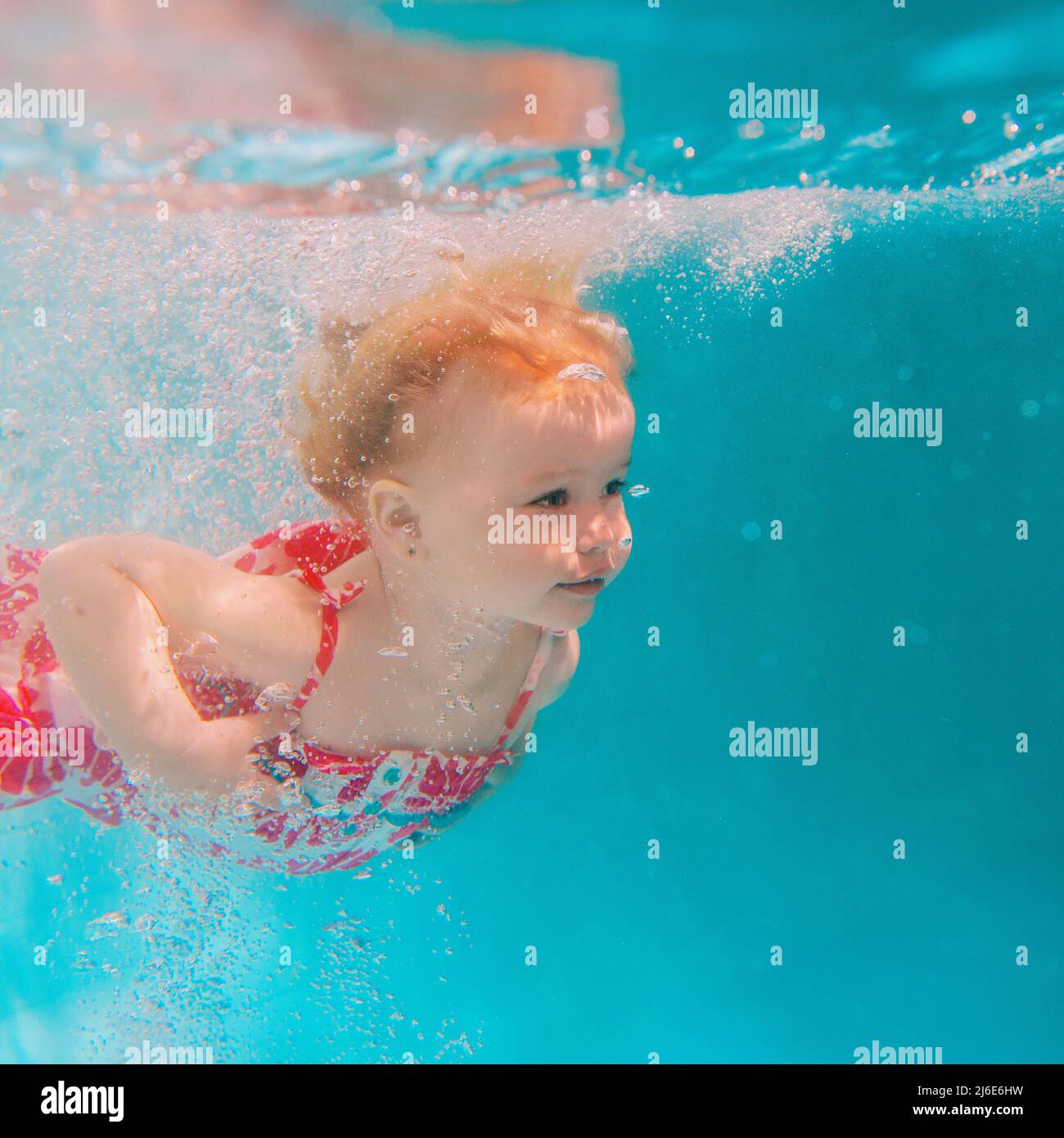 Parents and baby in swimming pool hi-res stock photography and images ...