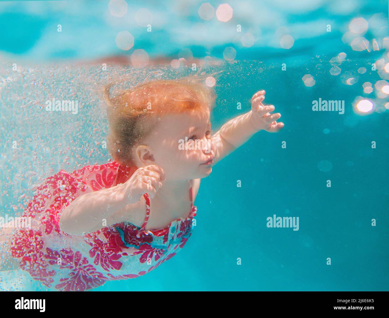 Parents and baby in swimming pool hi-res stock photography and images ...