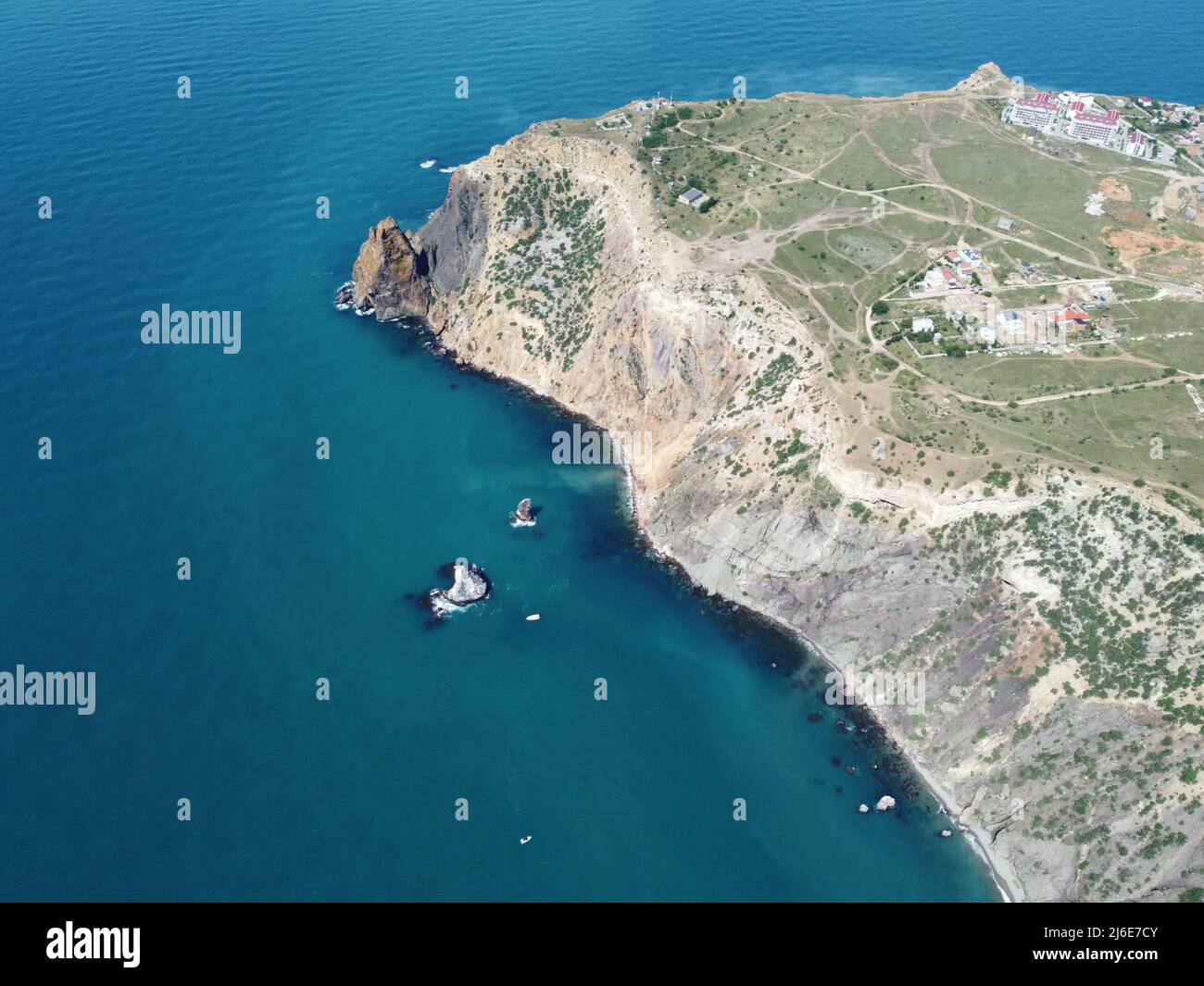 Aerial view from above on calm azure sea and volcanic rocky shores ...