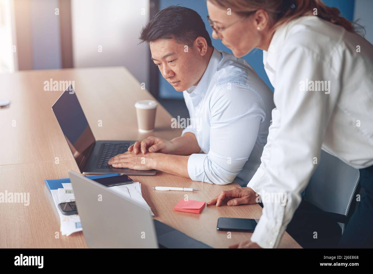 Focused female employee discussing online project, showing presentation ...