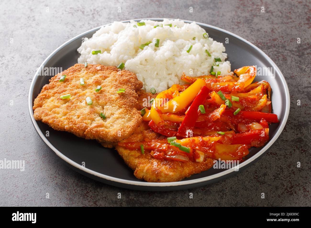 Homemade breaded schnitzel served with Gypsy sauce of bell peppers and ...