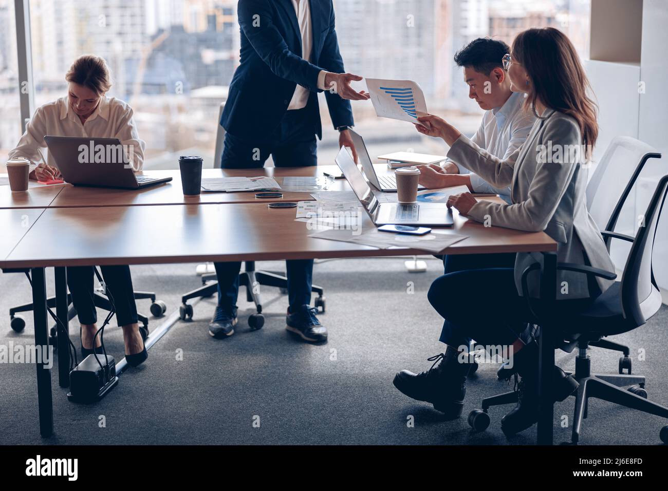 Close up team of businessmen working and communicating together in ...
