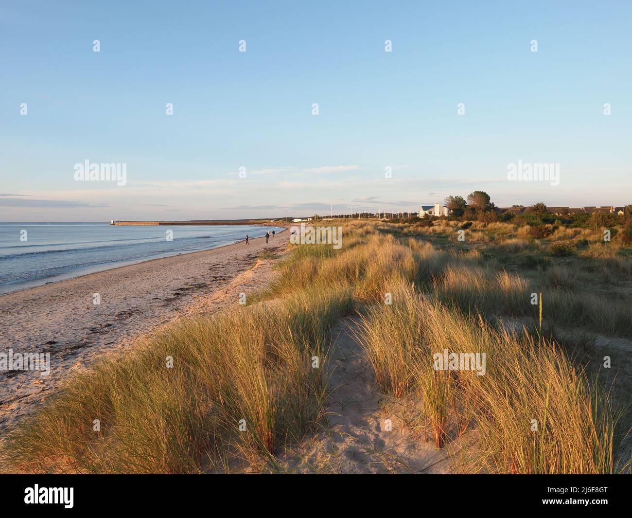The sunset glow on a summers evening on Nairn Beach. View looking ...