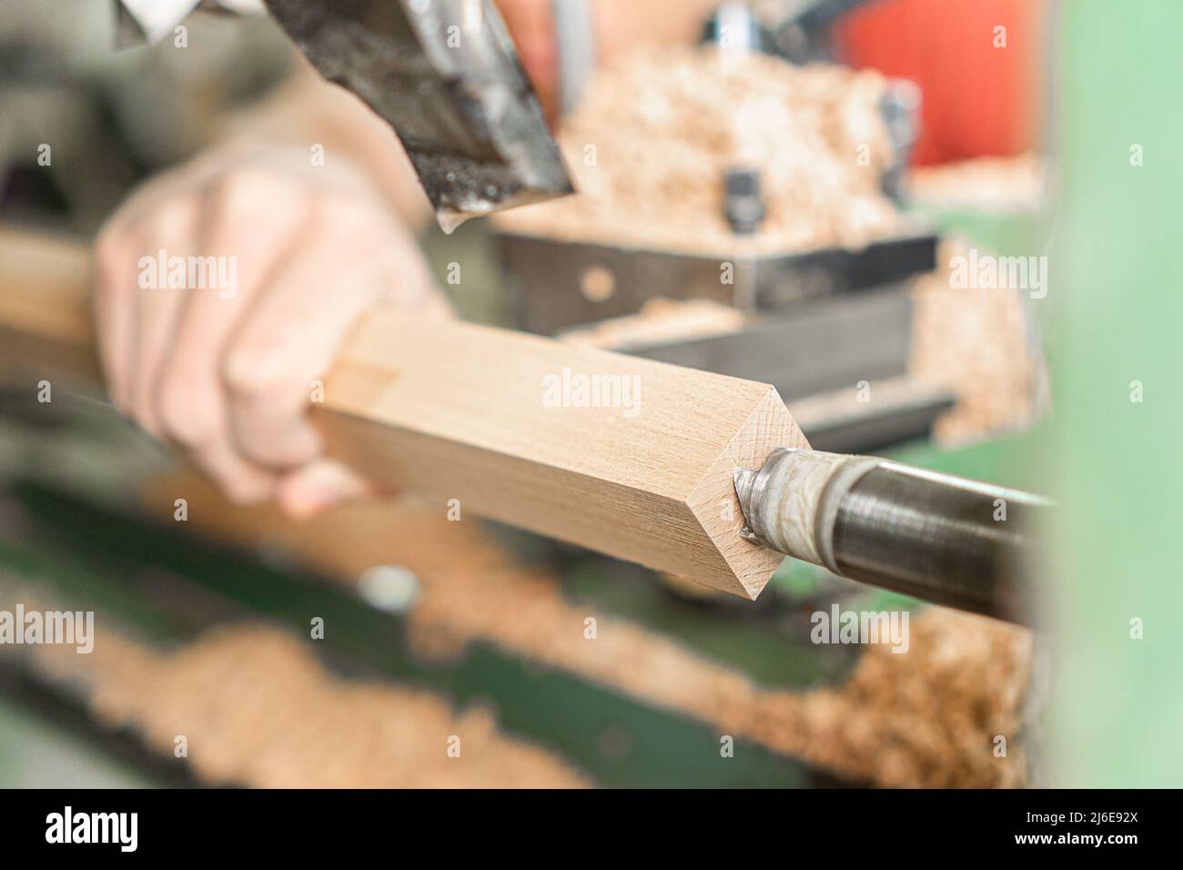 Crop handyman operating wood turning machine at work Stock Photo - Alamy