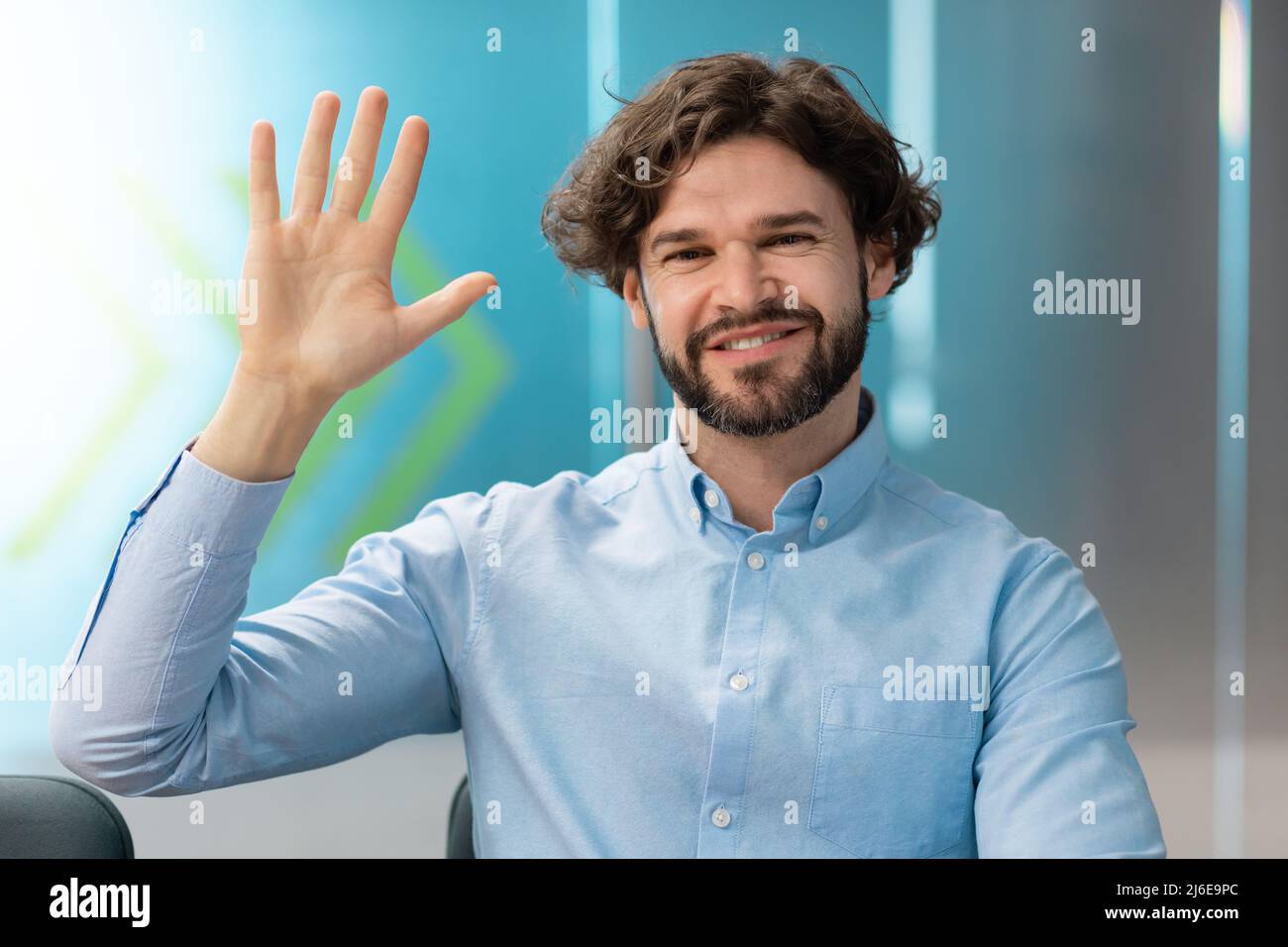 Greeting Concept. Smiling business man waving hand at camera Stock ...