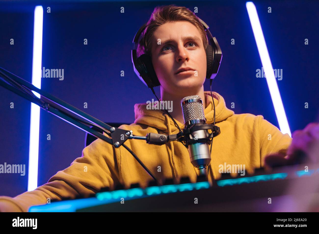 Portrait of concentrated pro gamer streaming online video game on his ...