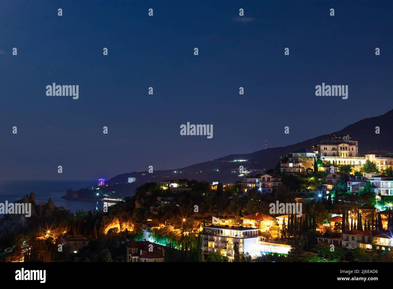 Night city view on coast of mediterranean sea with lights Stock Photo ...