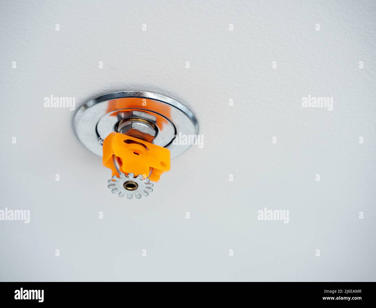 Close-up fire sprinkler, chrome and plastic orange color materials ...