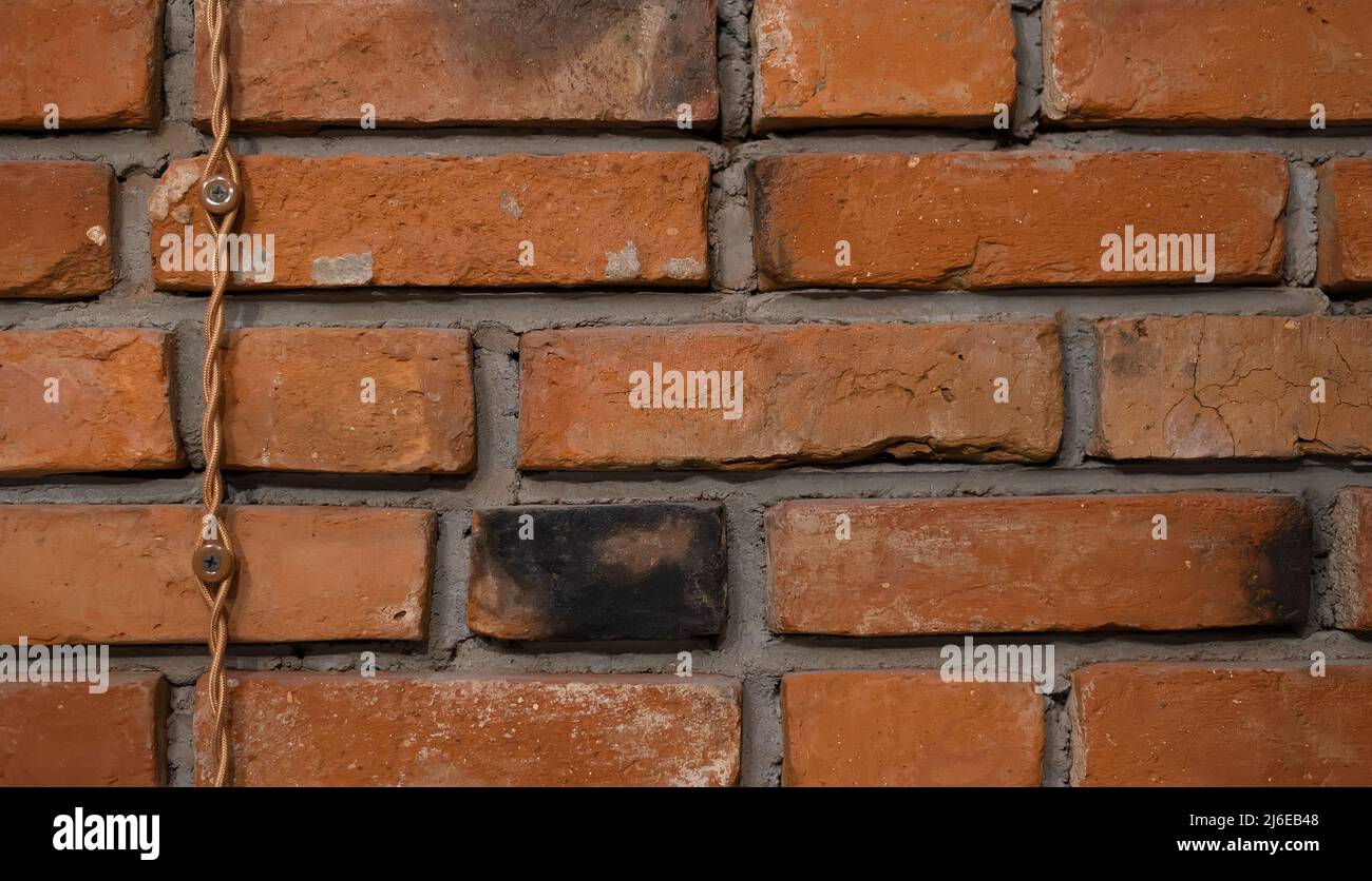 Bright red clay bricks wall with retro electric cable. Flat background ...