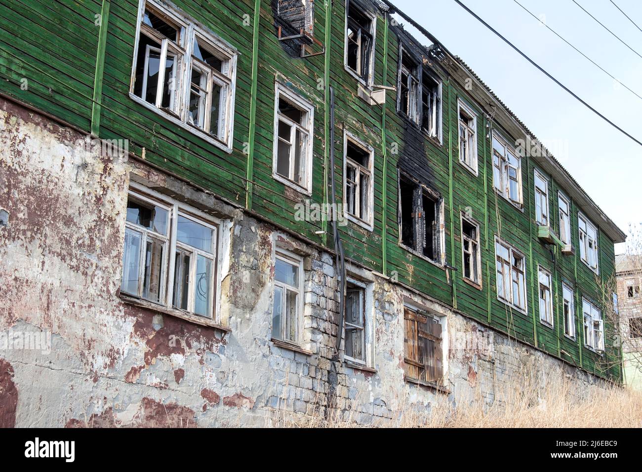 The old green paint wooden damaged burned-down house front view Stock ...