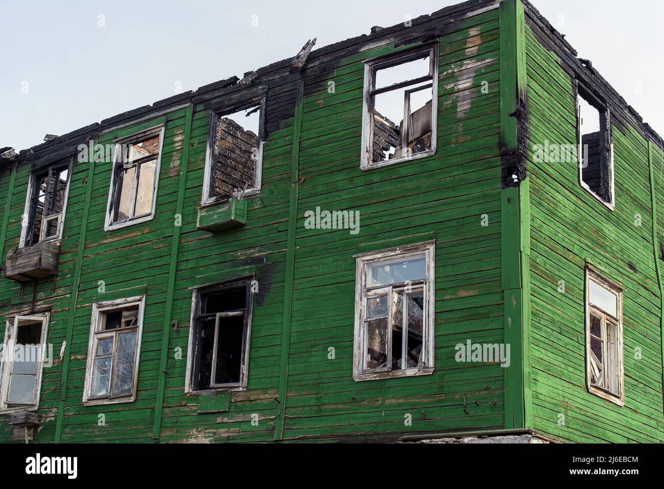 The old green paint wooden damaged burned-down house front view Stock ...