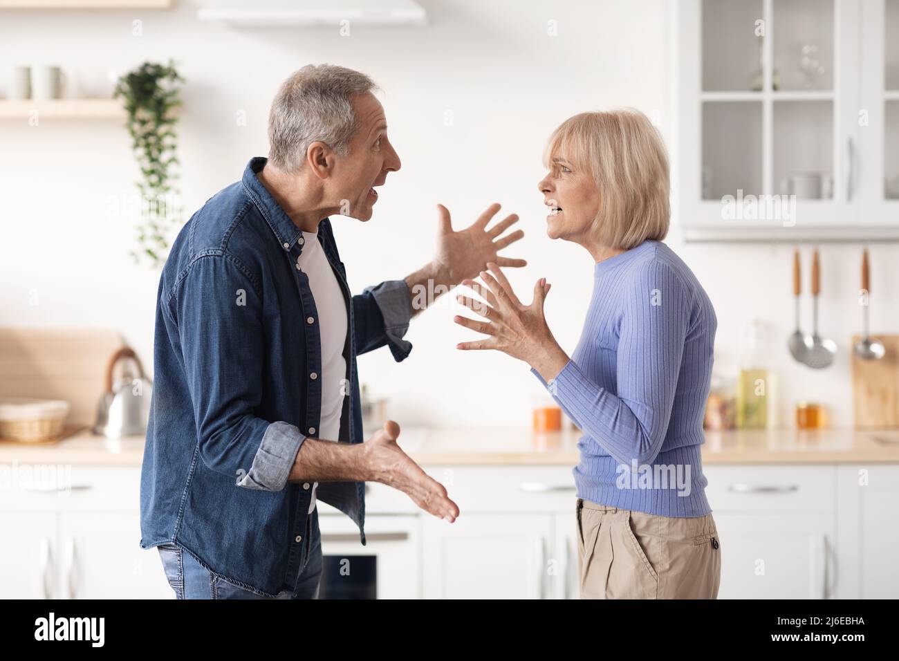 Elderly couple arguing during cooking lunch at kitchen Stock Photo - Alamy